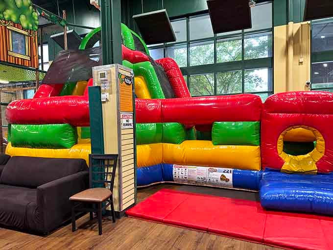 Rainbow-bright inflatables tower like a carnival came indoors and decided to stay forever, bless its heart.