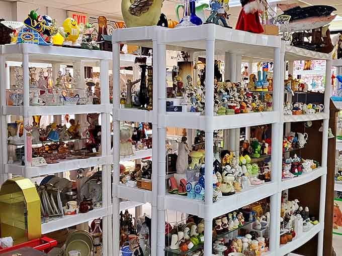 White shelving units packed with figurines prove someone's collection became your shopping opportunity today.