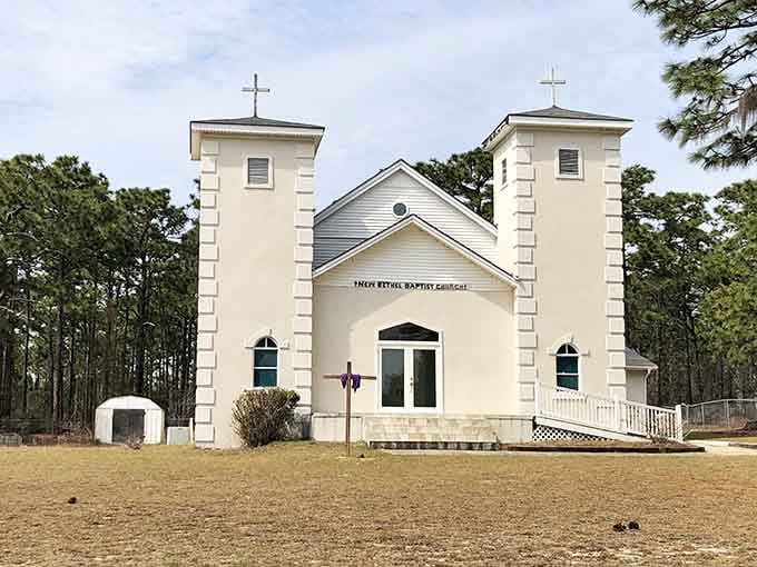 New Bethel Baptist Church stands proud with twin towers, a beacon of faith where services blend English and Gullah traditions.