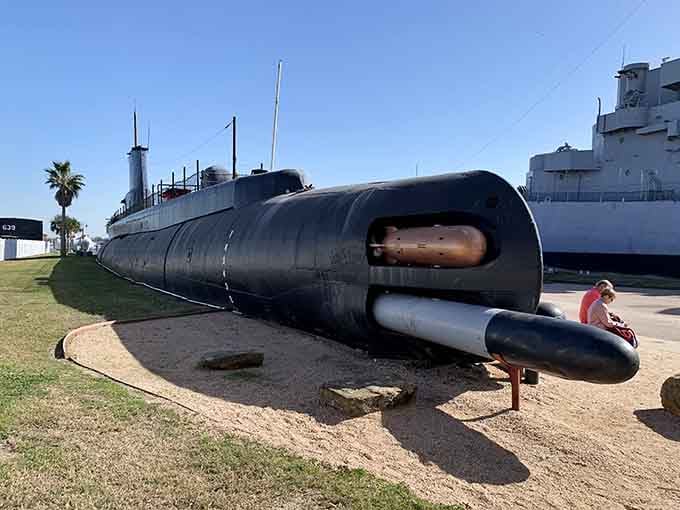 That sleek black submarine isn't a movie prop; it's the real USS Cavalla, complete with battle scars and stories.
