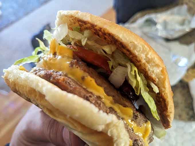 Look at that perfectly melted cheese cascading over the patty like a delicious yellow waterfall of happiness.