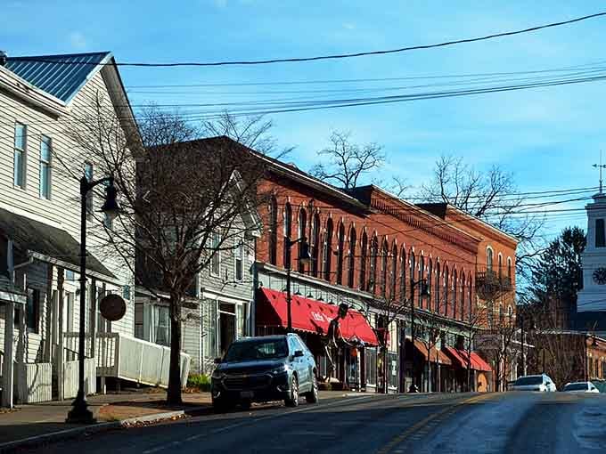 Red awnings and brick facades create that timeless Main Street America vibe we all secretly miss.