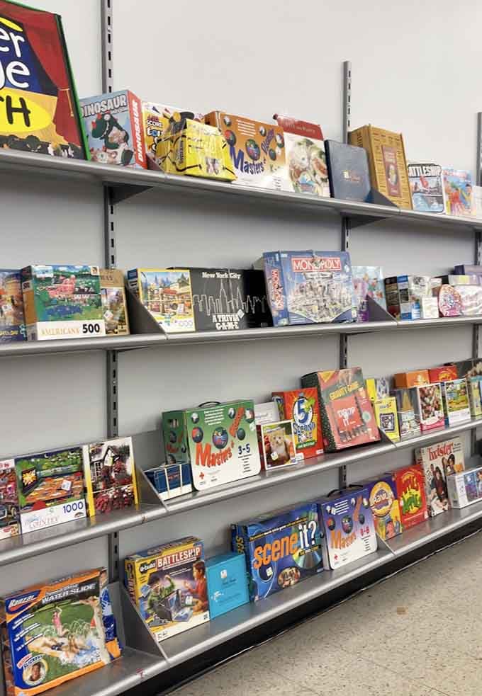 Board games and puzzles stacked like a nostalgic library, ready to rescue your next family game night from digital oblivion.