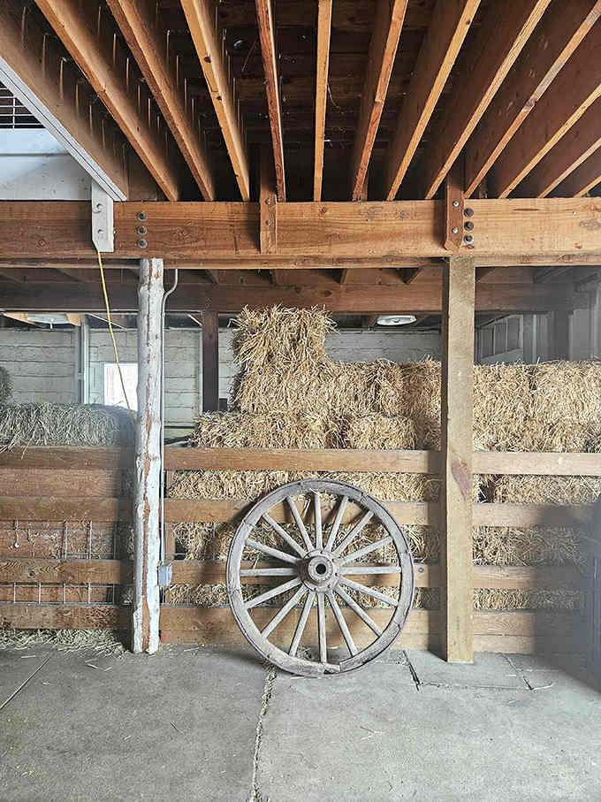 Stacked hay bales and vintage wagon wheels create an atmosphere straight out of a Norman Rockwell painting.