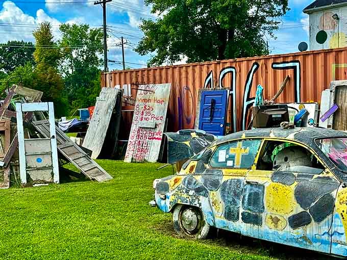 Weathered doors and painted wood lean against shipping containers, creating layers of meaning about urban renewal and memory.