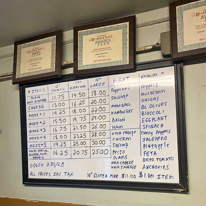 No fancy fonts or laminated menus here, just straightforward pizza options written with the confidence of knowing exactly what works.