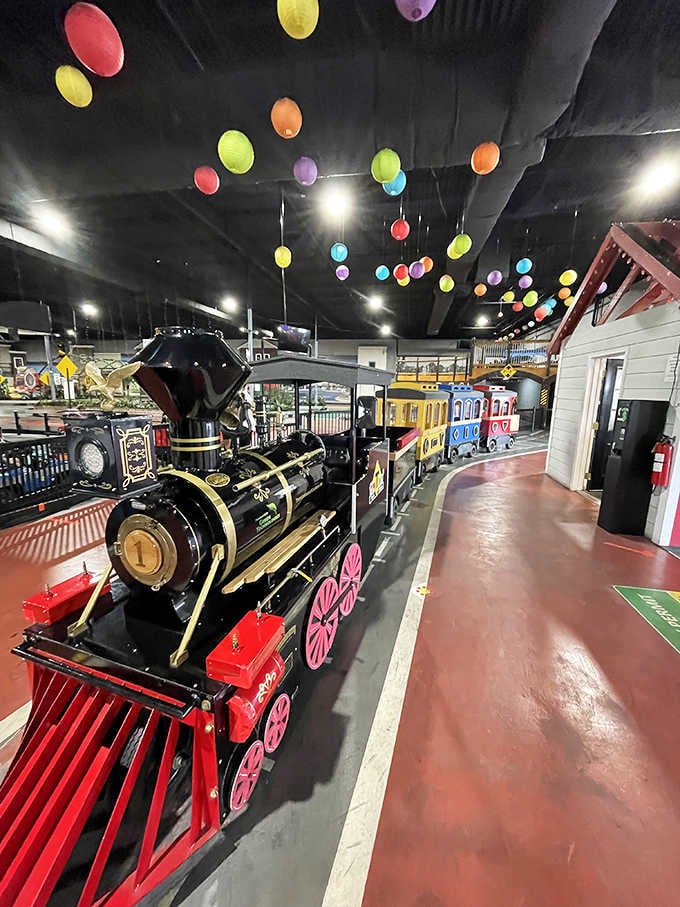 The classic train offers a leisurely tour while young drivers navigate below, creating a charming two-speed world.