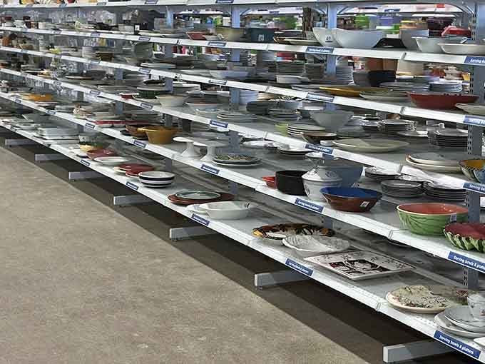 Plates, bowls, and platters organized like a museum of dining possibilities waiting for your next dinner party.