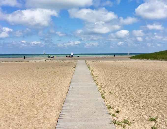A boardwalk stretching toward turquoise water that looks suspiciously like somewhere you'd pay triple to visit down south.