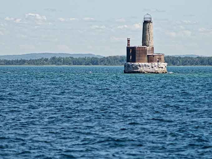 Two miles offshore, this lonely lighthouse watches over the waters it once protected with its guiding light.