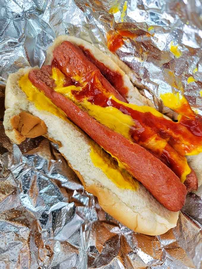 Behold the platonic ideal of a hot dog: mustard, ketchup, and pure contentment wrapped in foil.