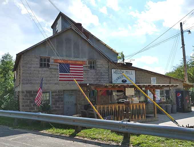The historic mill building stands proud, your gateway to river relaxation and summer memories.