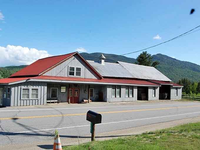 That red roof pops against mountain mist like a beacon calling hungry travelers to authentic Adirondack hospitality.