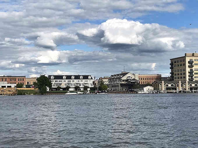 Dramatic clouds roll over the waterfront where historic architecture meets the timeless beauty of the Saginaw River.