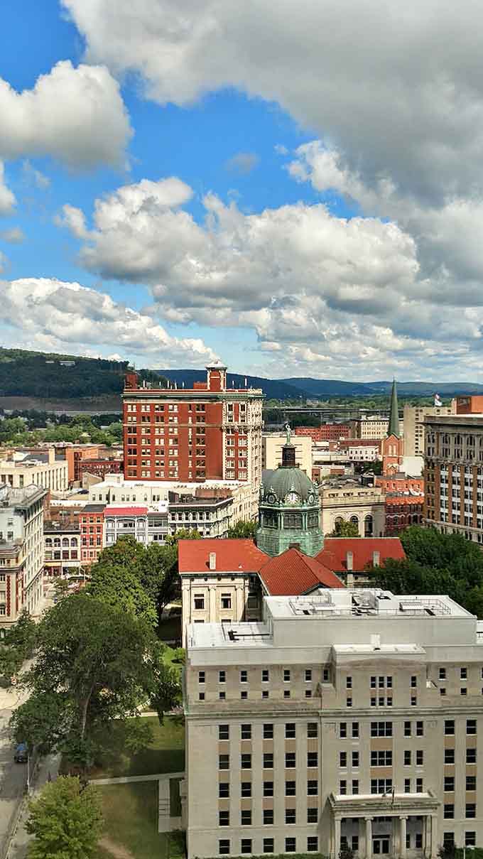 Rolling hills meet historic rooftops under dramatic clouds, creating a skyline that rivals any big city without the big-city attitude.