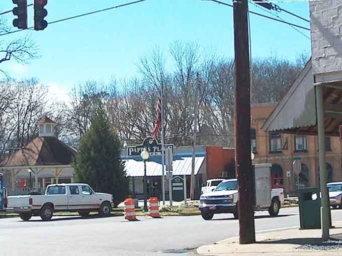 This charming intersection captures small-town life where traffic jams mean waiting for one car to pass by.