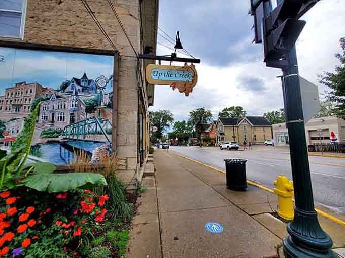 That colorful mural and "Up the Creek" sign prove small towns have more personality than most big-city neighborhoods combined.