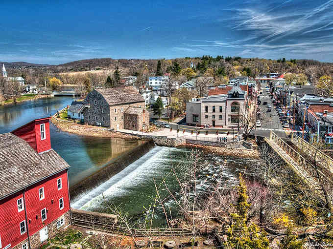 The red mill and rushing waterfall create a scene so perfect, Norman Rockwell would've set up his easel.