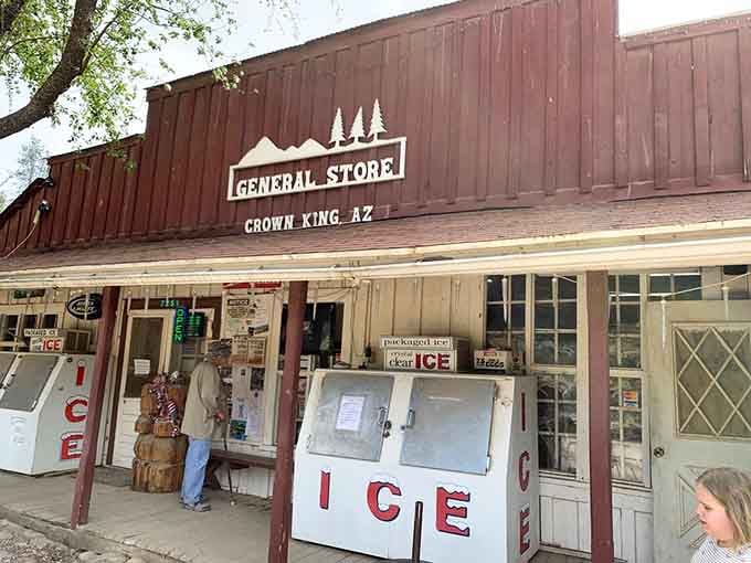Red barn siding and pine trees frame this mountain retreat where "one stop shop" means cold beer and ice.