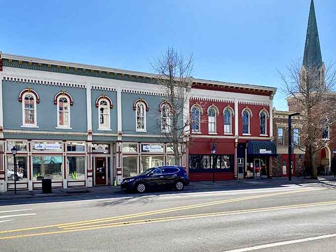 Winter trees frame these painted facades like nature's own picture frame around small-town Americana at its finest.