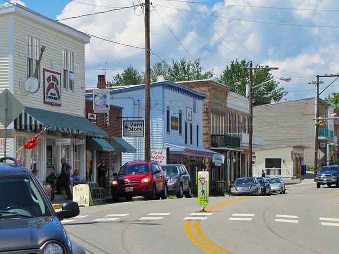 Those striped awnings and weathered storefronts tell you this town has been welcoming visitors for generations, not seasons.