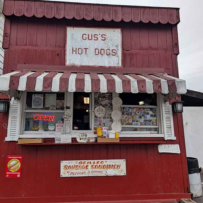 That weathered red siding and striped awning have seen more happy customers than a Beatles reunion tour.