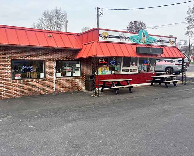 The cheerful red roof and turquoise signage make this brick building impossible to miss from the road.