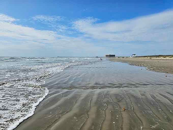 The tide creates rippled patterns in the sand like nature's own zen garden, only wetter.