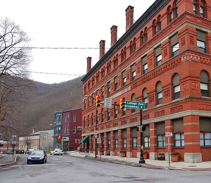 Mountains frame this red-brick beauty like nature's own picture frame at golden hour.
