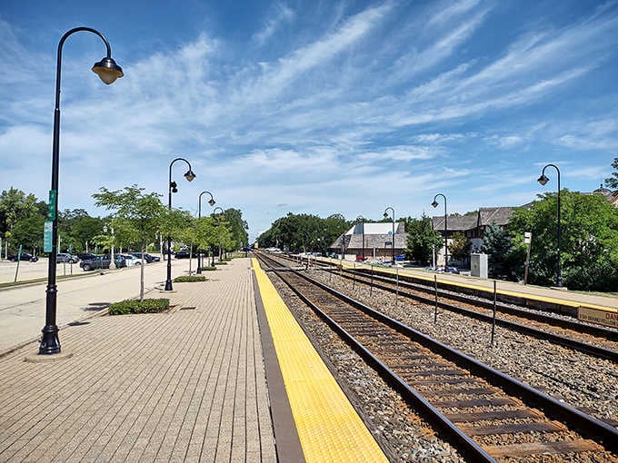 The train platform stretches into the distance under perfect skies, offering city connections while maintaining that peaceful suburban atmosphere.