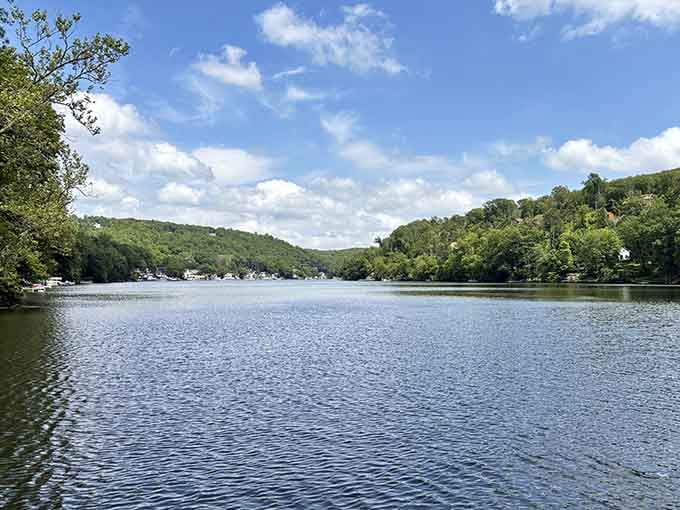 Rolling hills embrace the water on both sides, creating a natural amphitheater that would make any landscape architect jealous.