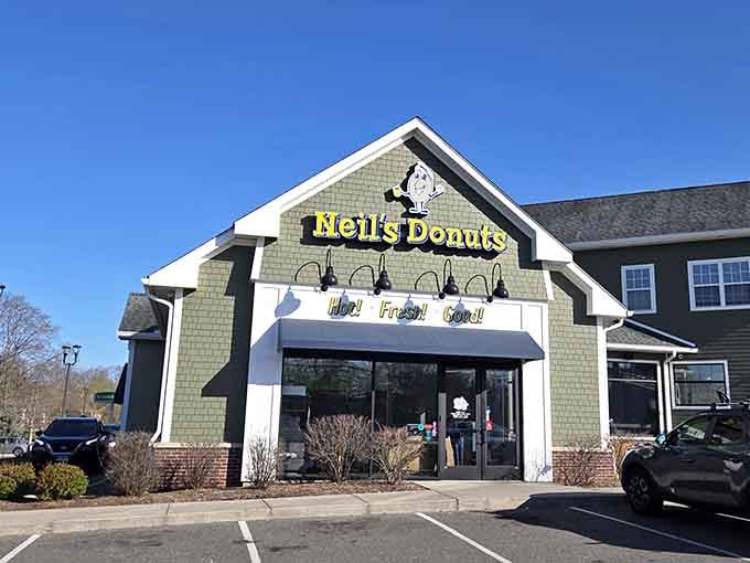 The peaked roof and welcoming entrance signal a neighborhood treasure where donuts are taken seriously, deliciously so.