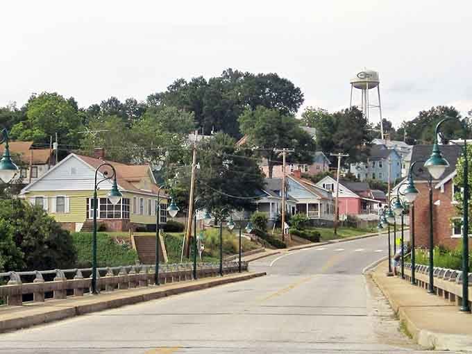 Rolling streets and a water tower standing sentinel over this mill town where time moves at river speed.
