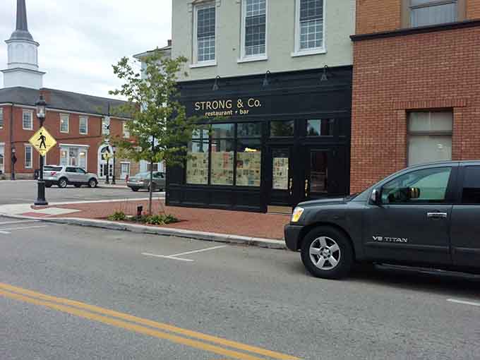 That black storefront proves even contemporary design can respect the character of a historic Main Street beautifully.