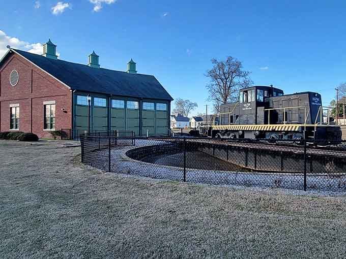 The turntable and roundhouse area showcases railroad engineering that would make any train enthusiast's heart skip a beat.