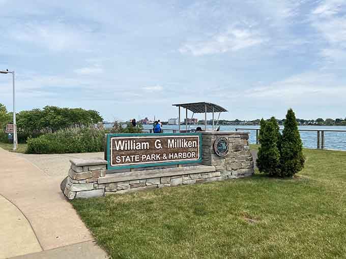 The welcome sign stands proud against the Detroit River, where urban parks prove cities can have green spaces too.