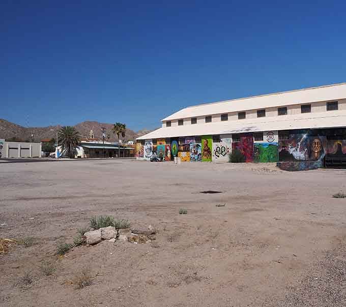 Vibrant street murals add splashes of color to this quiet plaza where history meets contemporary desert art.