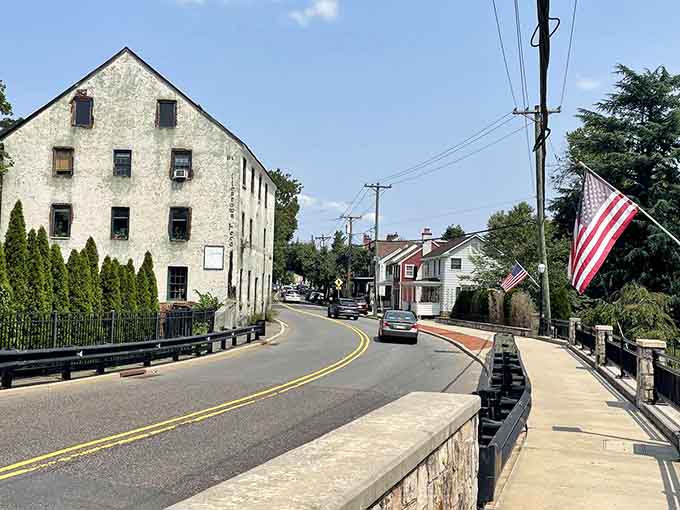 The American flags wave over stone bridges and quiet streets where Revolutionary War soldiers once marched.
