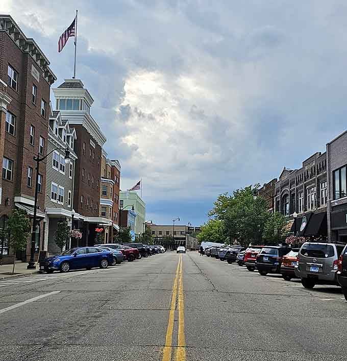 Nothing says home like a grand flag flying over brick buildings as the sun breaks through those dramatic clouds.
