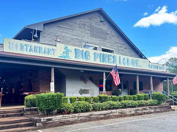 Flags flying proudly above manicured hedges signal this lodge takes both patriotism and fried catfish seriously.