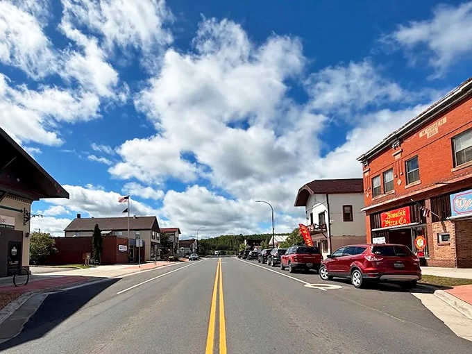 Those dramatic clouds rolling over the brick buildings create a scene worthy of any classic American road trip film.