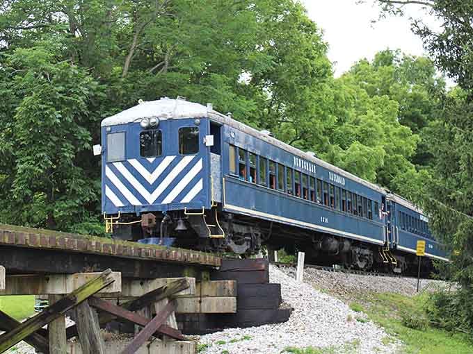 Those bold blue and white chevrons catch your eye as the train crosses an old wooden trestle bridge.