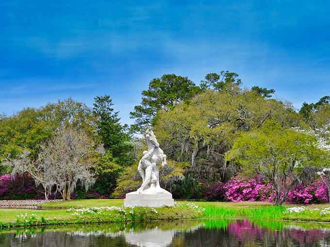 A classical statue stands guard over a reflecting pool where even the water looks like it's posing for pictures.