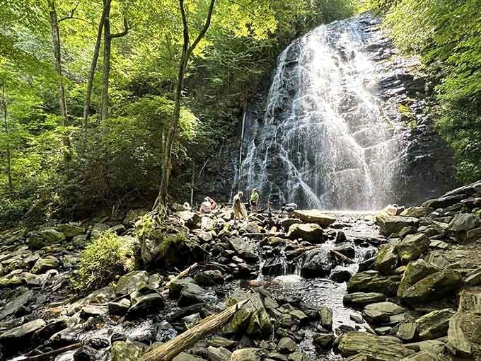 Summer visitors cool off in the misty spray while moss-covered rocks frame this magnificent cascade perfectly.
