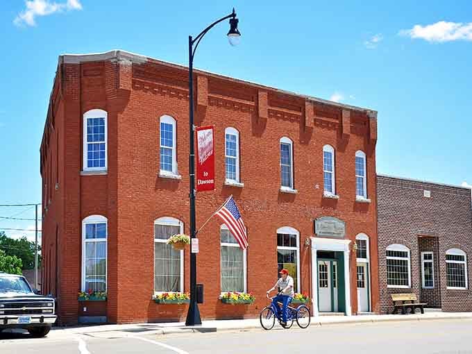 Red brick beauty with flower baskets and patriotic flags shows a community that takes pride in every detail.