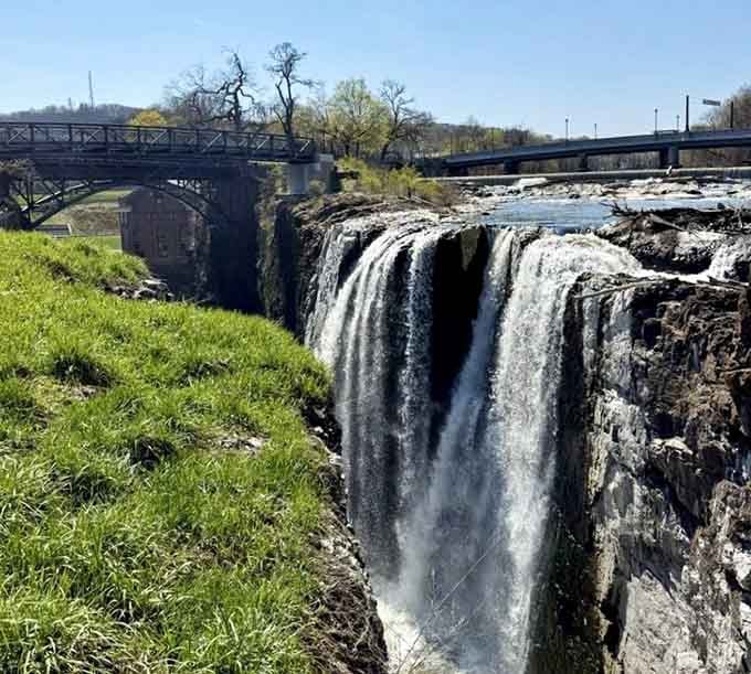 Spring sunshine illuminates this thundering cascade, where industrial history and natural beauty shake hands across the centuries.