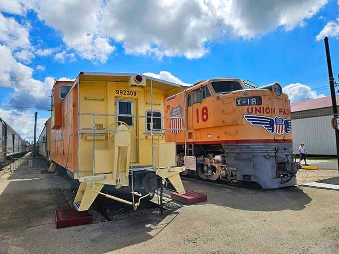 That bright orange locomotive stands ready like it's still got places to go, a powerful reminder of America's golden age.