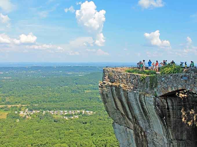 Brave souls gather at the edge where earth meets sky in one breathtaking, slightly terrifying moment.