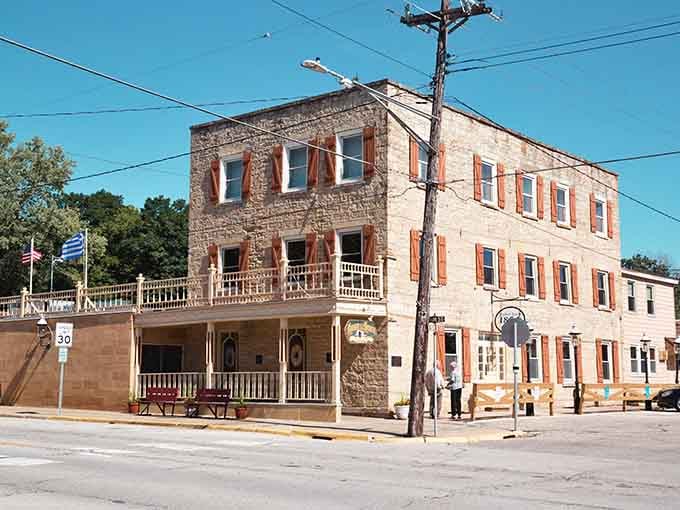 This gorgeous stone corner building in Mantorville, with its rust-colored shutters and wraparound porch, is the architectural equivalent of a firm, friendly handshake.