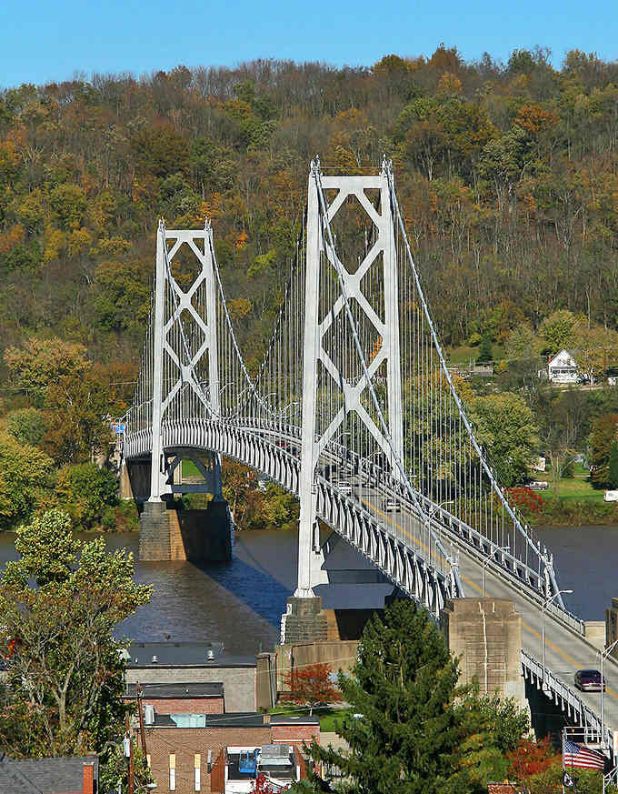 This graceful white bridge spanning the river looks like something from a postcard your grandparents might have sent.